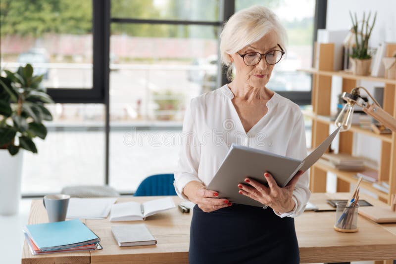 Professional Hard Working Businesswoman Reading a Report Stock Photo ...