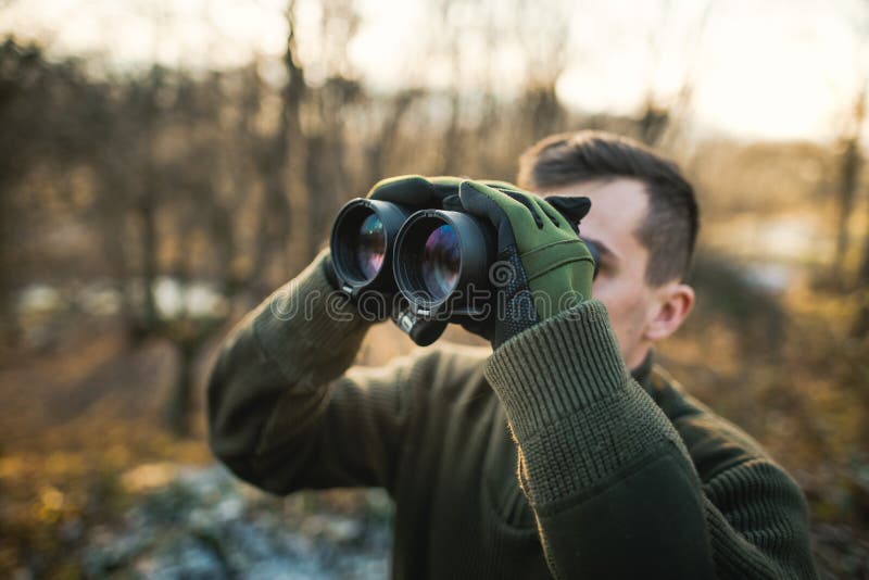 Professional Hunter Looking through Binoculars. Man on the Hunt in the ...