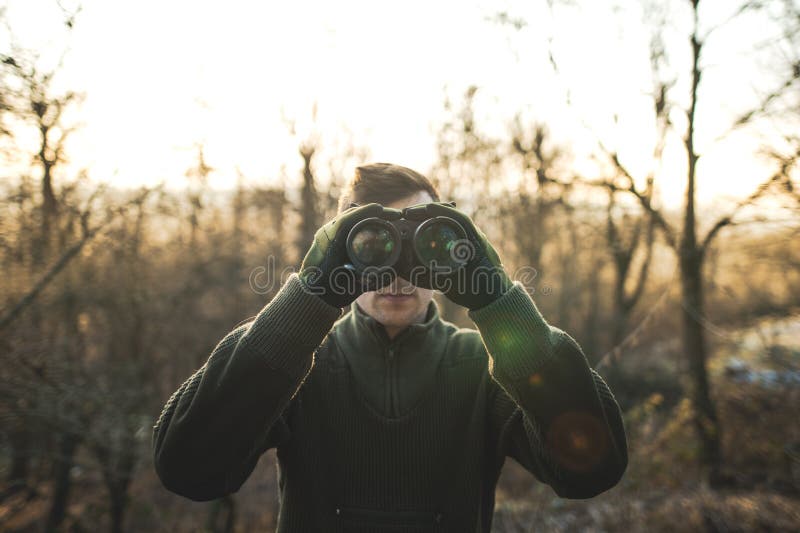 Professional Hunter Looking through Binoculars. Man on the Hunt in the ...