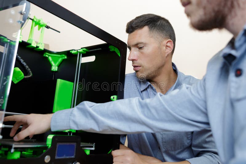 Professional Industrial Engineers Adjusting Modern Machine Settings ...