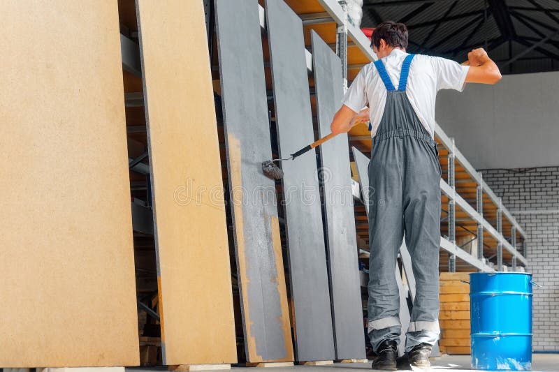 Professional Industrial Painter Paints Wooden Boards with Paint Roller ...