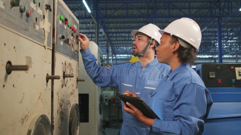 Industry Engineer Teams Inspect Machine Control Panels in Manufacturing ...
