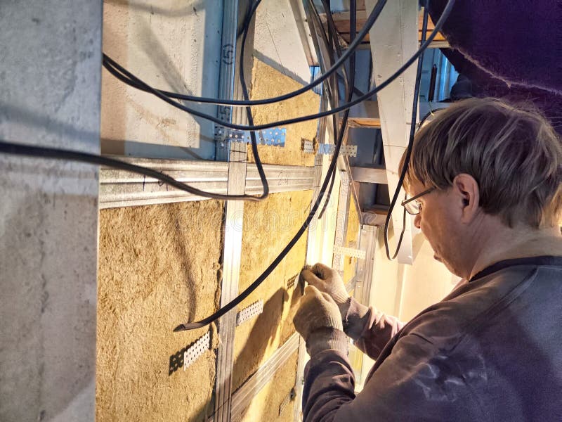 Professional Installs Drywall during Home Renovation. a Skilled Worker ...