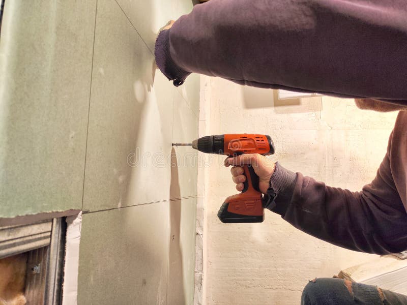 Professional Installs Drywall during Home Renovation. a Skilled Worker ...