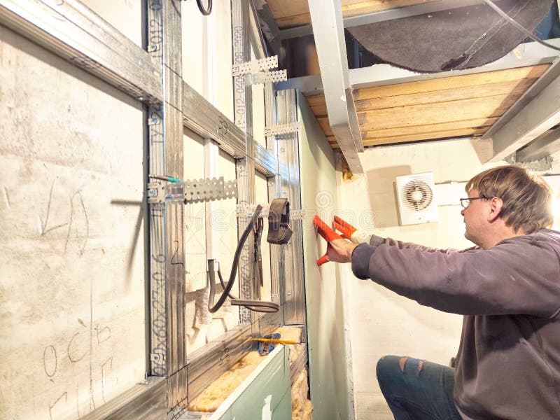 Professional Installs Drywall during Home Renovation. a Skilled Worker ...