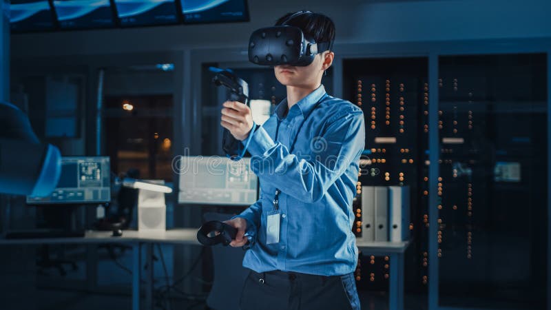 Professional Japanese Development Engineer in Blue Shirt is Using Augmented Reality Head Stock ...