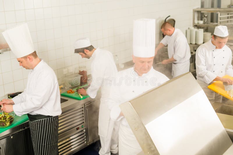 Cook in industrial kitchen stock photo. Image of interior - 34864862