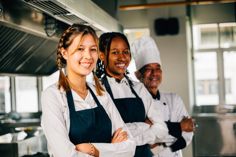 In a Professional Kitchen Smiling Chefs in Uniform Pose for a Portrait ...