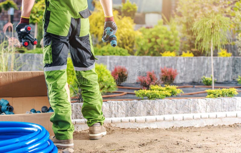 Landscaping Worker Installing Fresh Lawn Made from Natural Grass Stock ...