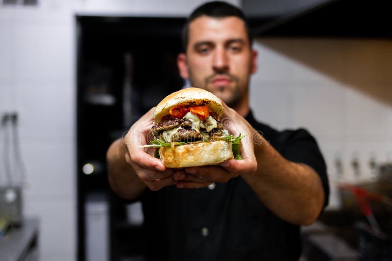 Professional Latin Chef Holding a Prepared Hamburger Stock Image ...