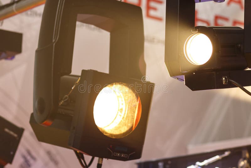 Professional Lighting Fixtures with a Rotating Head are Suspended on a ...