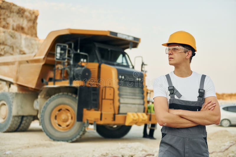 Professional Loading Vehicle. Worker in Uniform is on the Borrow Pit at ...