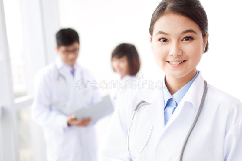Cheerful Smiling Female Doctor on the Background with Doctor and His ...