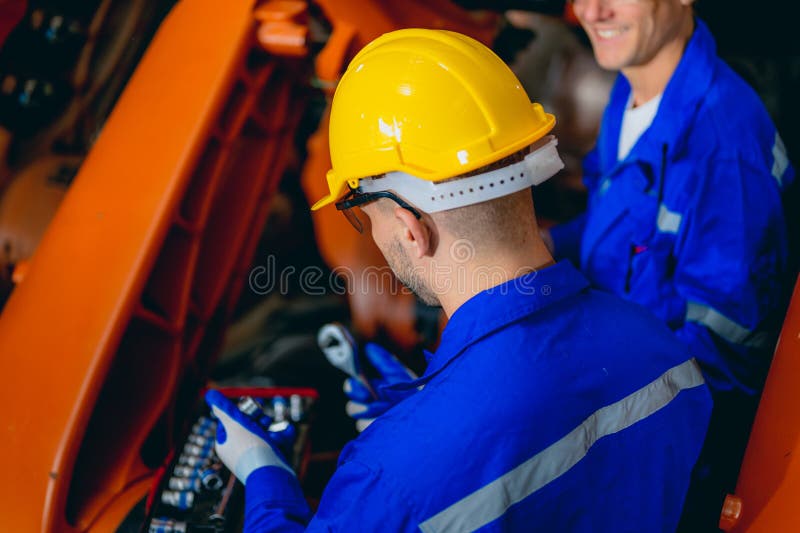 Professional Maintenance Worker with Machine Robotic Arms at Industrial Factory Stock Image ...