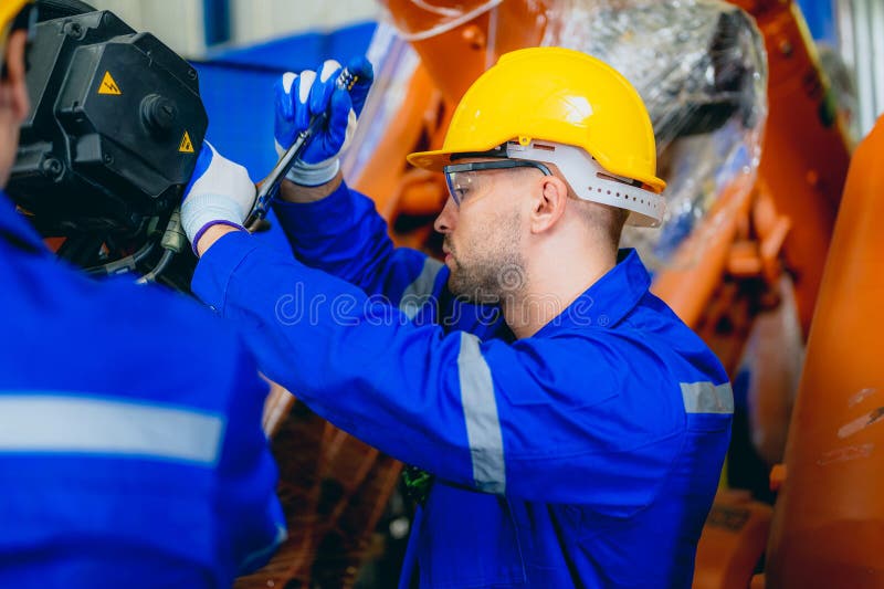 Professional Maintenance Worker with Machine Robotic Arms at Industrial ...