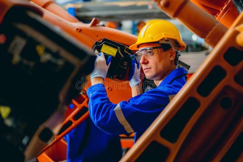 Professional Maintenance Worker with Machine Robotic Arms at Industrial ...