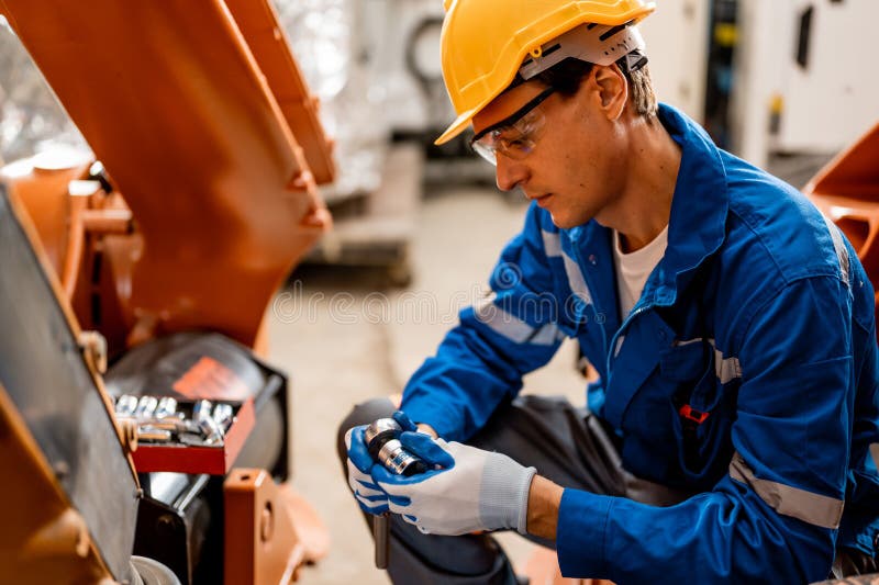 Professional Maintenance Worker with Machine Robotic Arms at Industrial ...