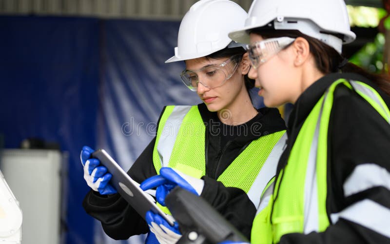Professional Maintenance Worker with Machine Robotic Arms at Industrial Factory Stock Photo ...