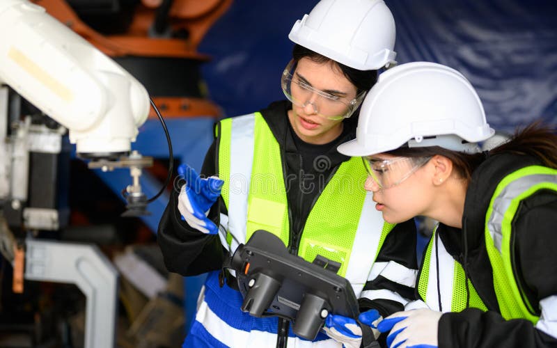 Professional Maintenance Worker with Machine Robotic Arms at Industrial ...