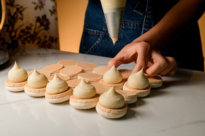 Professional Makes the Macaron Filling with Light Brown Cream Stock ...