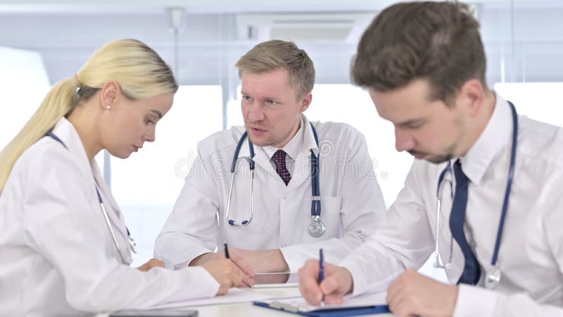 Professional Male Doctor Teaching Team on Paper in Office Stock Video ...