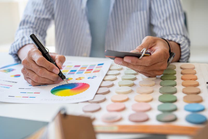 A Professional Male Interior Designer Working at His Desk in the Studio ...
