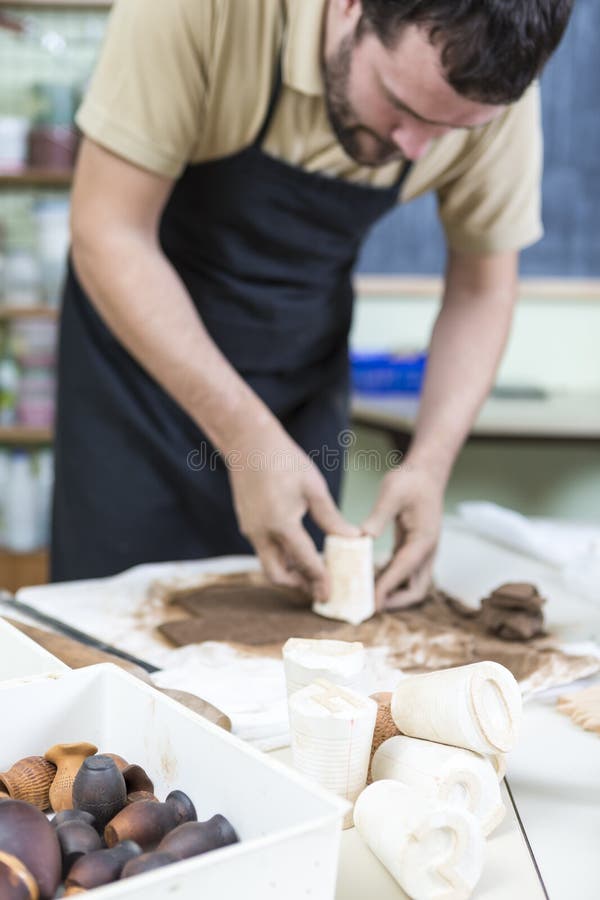 Professional Male Potter Pressing a Piece of Wet Flat Clay with Mould ...