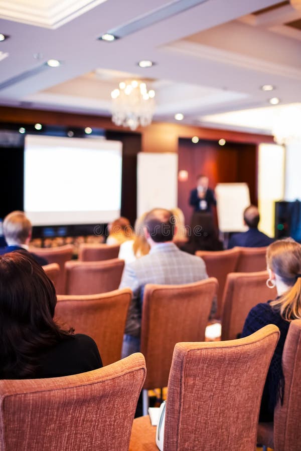 Professional Male Presenter Speaking in Front of the Group of People in ...