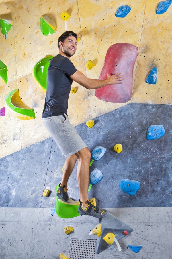One Rock Climber Man Hanging on a Bouldering Climbing Wall, Inside on ...
