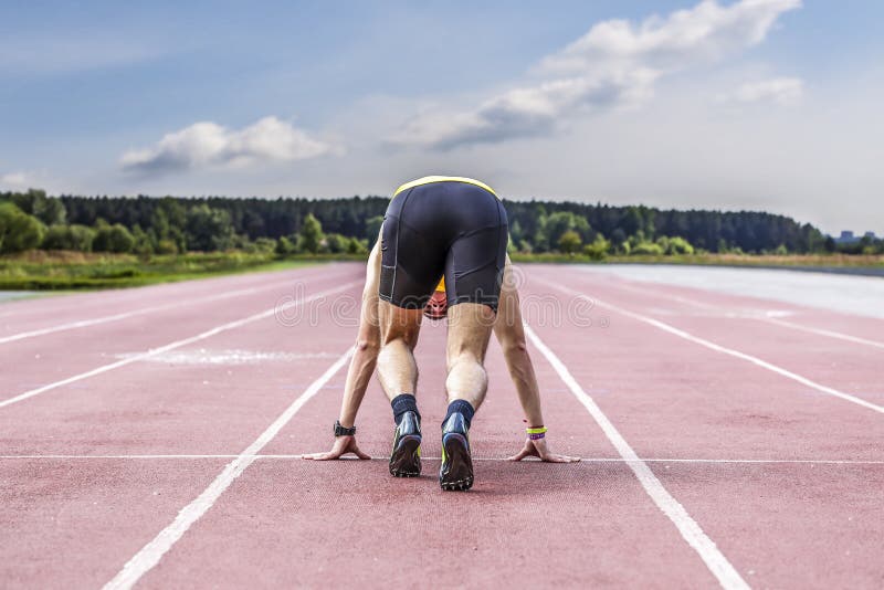 Professional Male Runner Taking Ready To Start Position Stock Image ...
