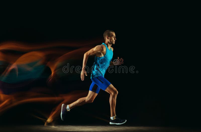 Professional Male Runner Training Isolated on Black Studio Background ...