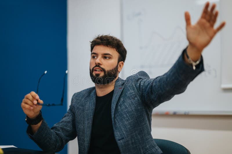 Professional Man Gesturing while Making a Presentation in Office Stock ...