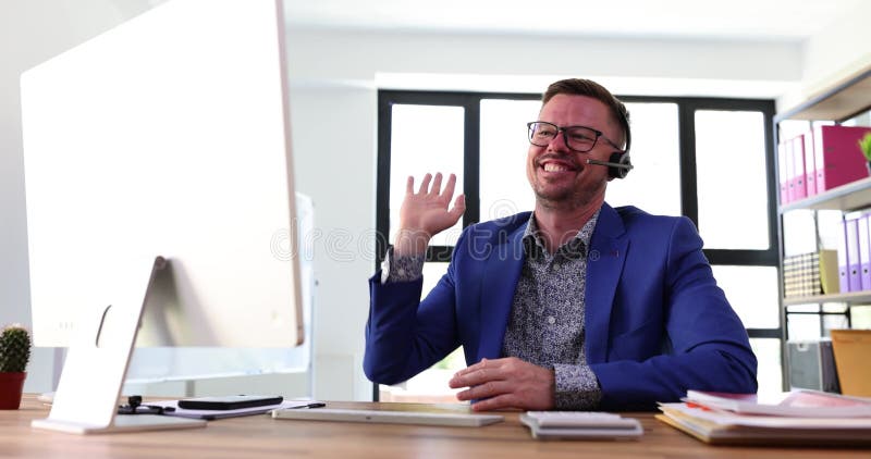 A Professional Man Participates in a Virtual Meeting with a Headset in ...