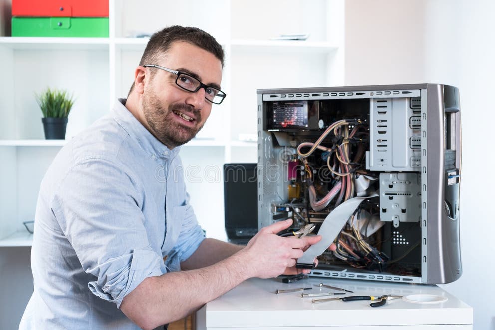 Professional Man Repairing and Assembling a Computer Desktop Stock ...