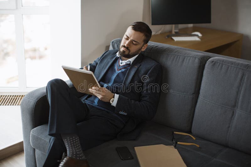 Focused Businessman Taking Notes on Sofa in Modern Office Stock Photo ...