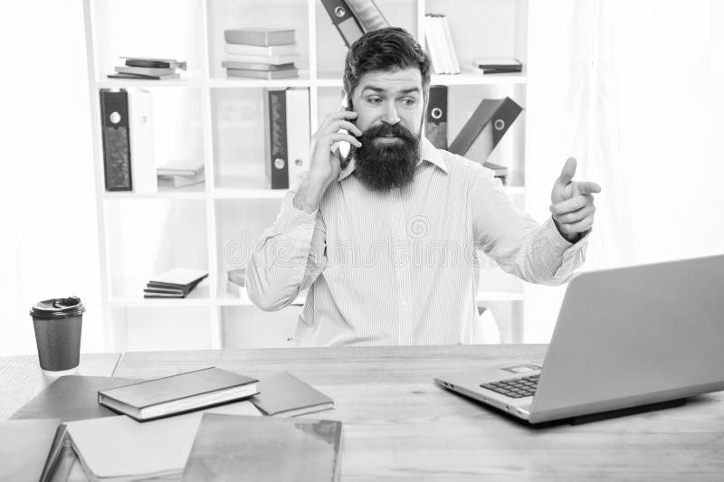 Professional Man Talking on Mobile Phone Working on Laptop in Office ...