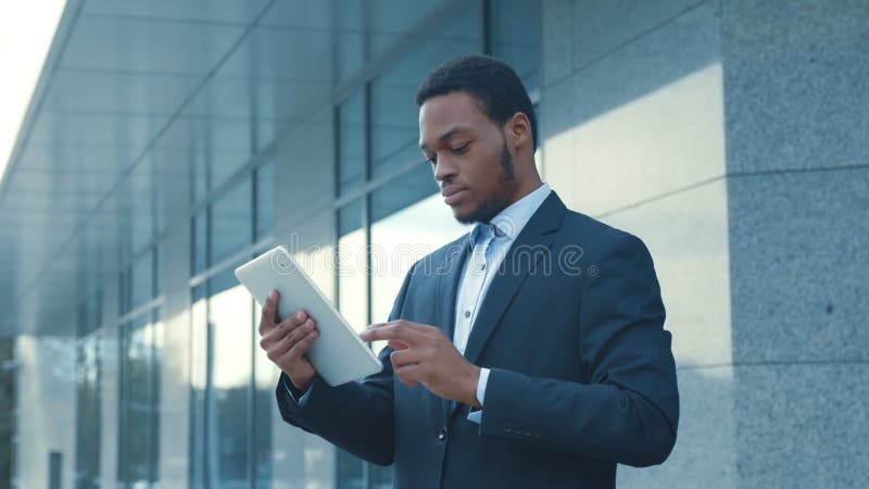 Professional Man Using a Tablet Outside a Modern Office Building Stock ...