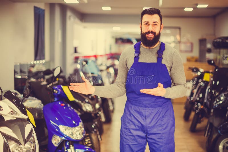 Professional Man Worker Displaying Various Motorcycles in Workshop ...