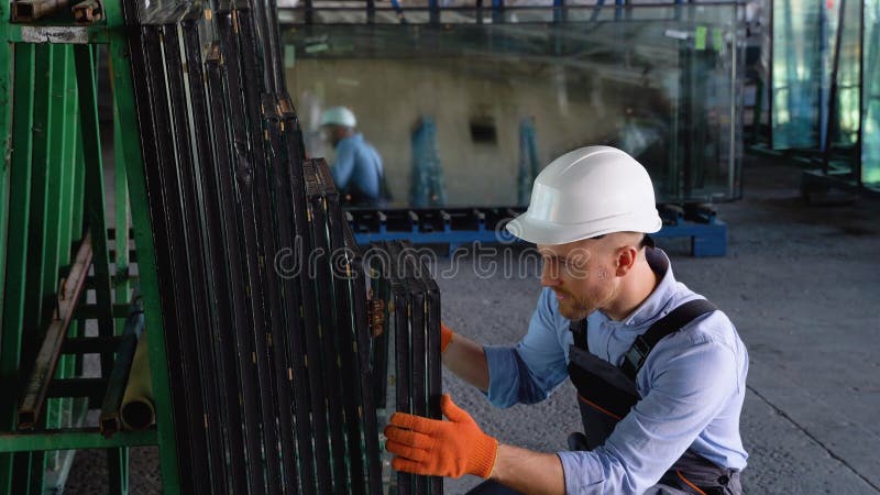 Professional Man Worker in a Window Warehouse Prepares Windows for ...