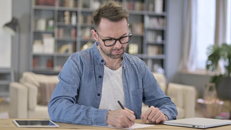 Professional Man Writing on Paper in Loft Office Stock Image - Image of ...