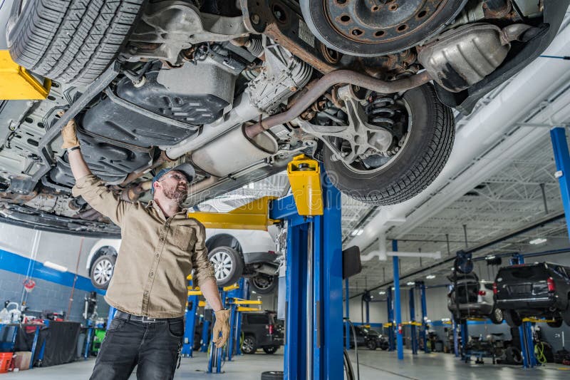 Professional Mechanic Checking Vehicle Undercarriage Stock Photo ...