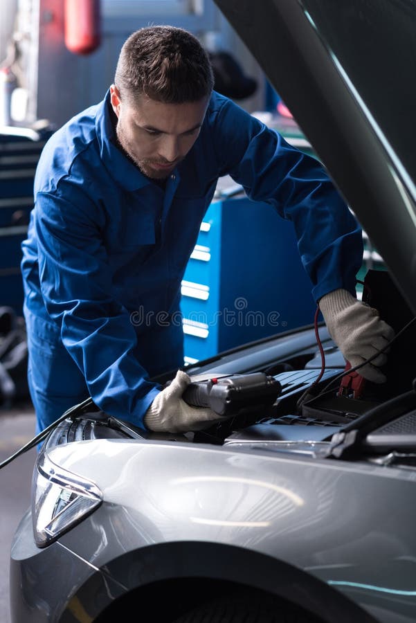 Professional Mechanic Examining Engine Stock Photo - Image of together ...