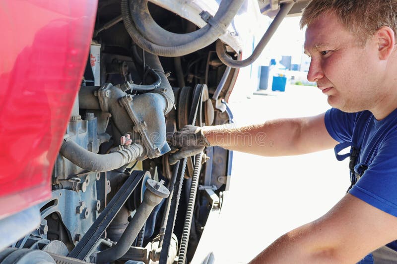 Professional Mechanic Inspects and Repairs Bus Engine. Stock Photo ...
