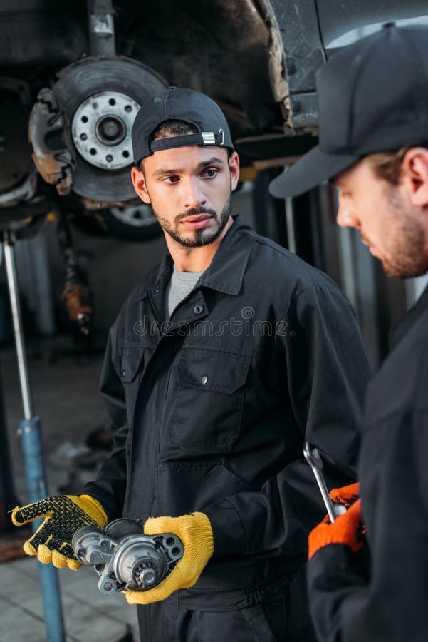 Professional Mechanics Repairing Car without Wheel Stock Image - Image ...
