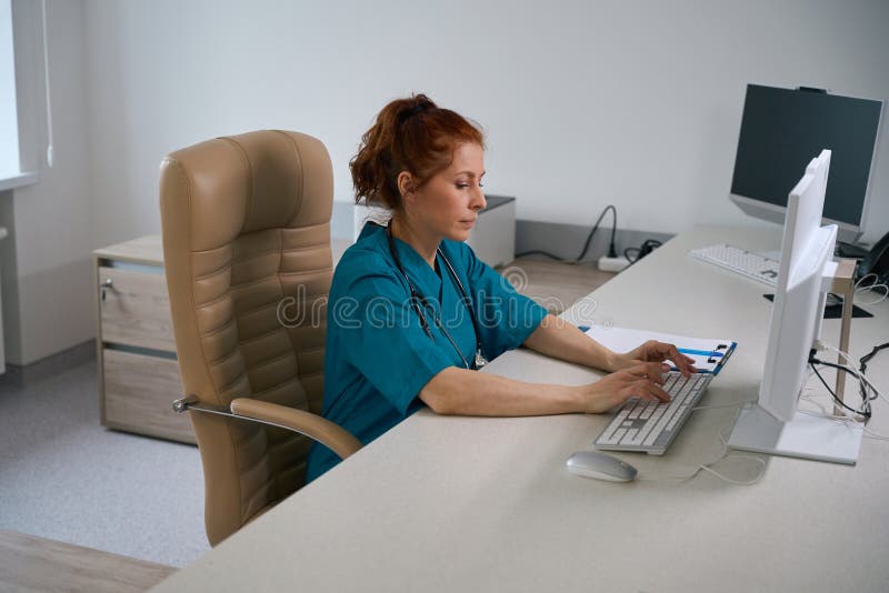 Professional Medic Typing on Computer Keyboard at Workplace in Clinic ...