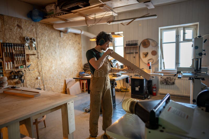 Professional Meticulous Carpenter Inspecting Wooden Beam Quality before ...
