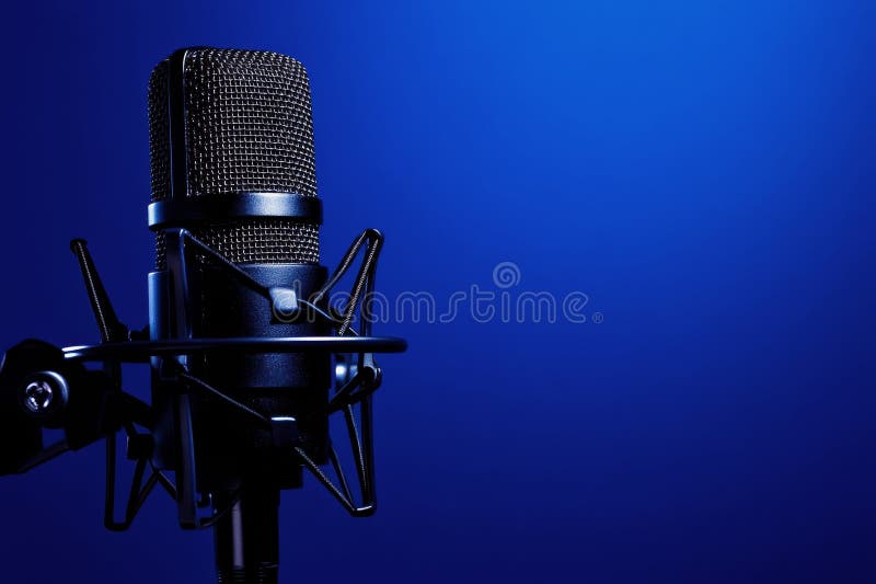 Professional Microphone Setup Against a Blue Backdrop in a Recording ...