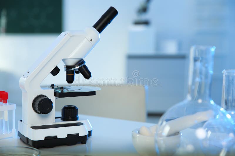 Professional Microscope and Glassware on Table in Chemistry Laboratory ...