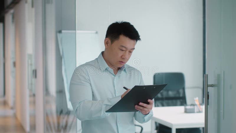 Professional Middle Aged Asian Man Auditor Making Inventory at ...