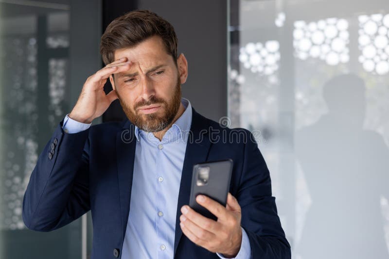 Worried Businessman Checking Phone with a Concerned Expression Stock ...